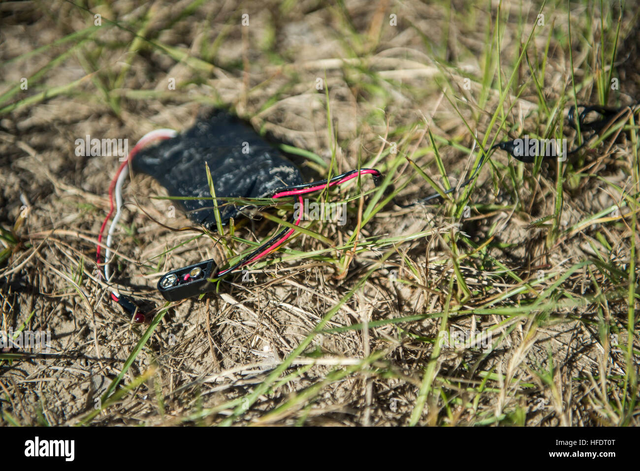 Remnants of a simulated improvised explosive device are analyzed by ...