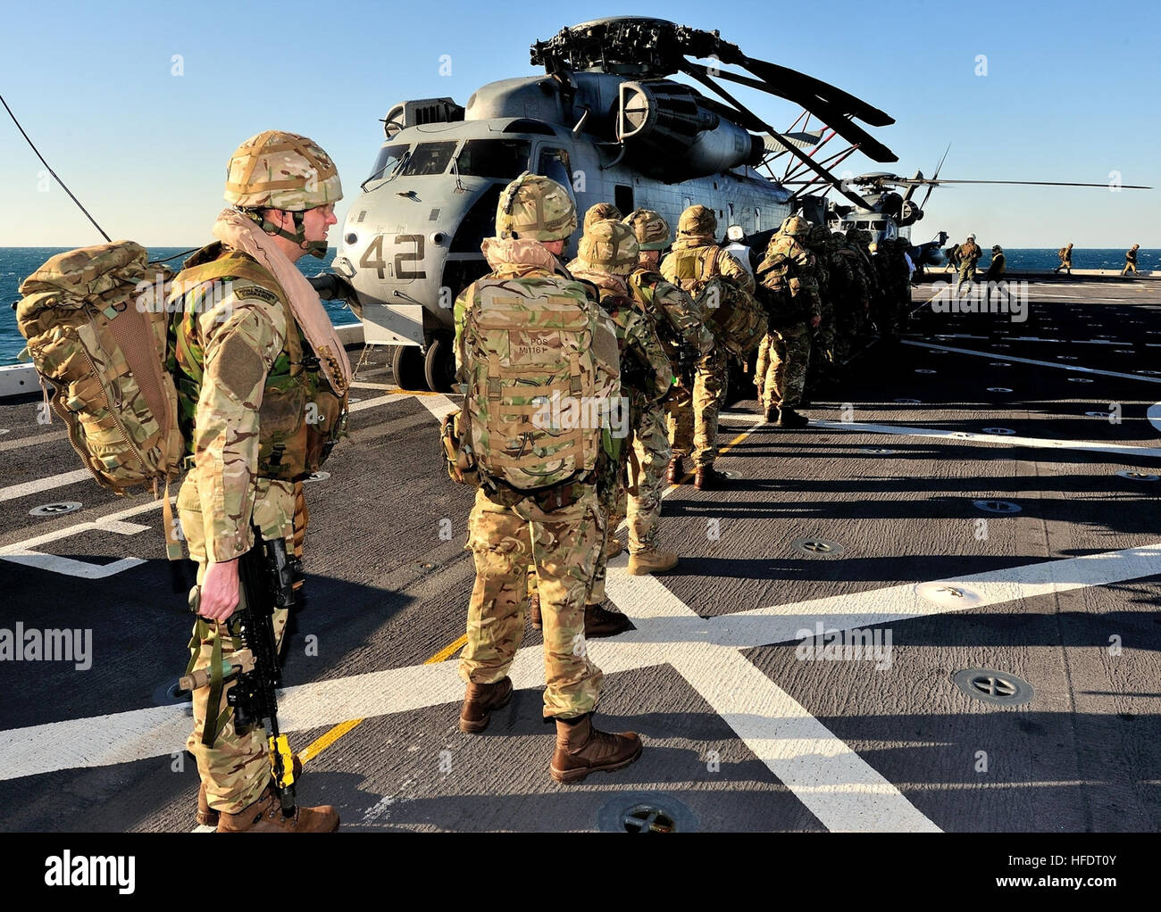 Royal Marines embark a CH-53 Super Stallion helicopter during a battle ...