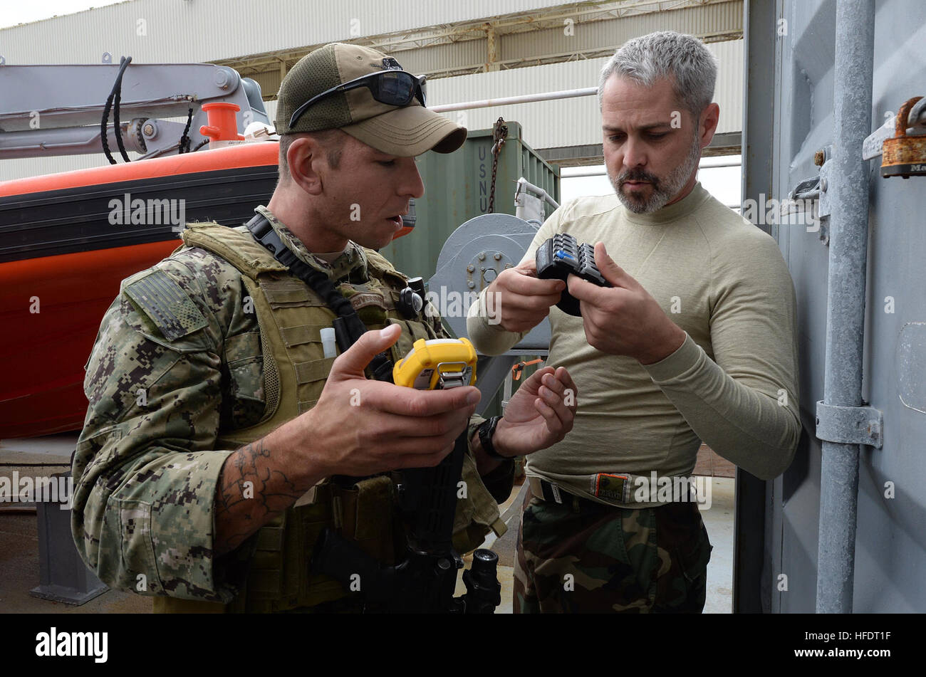 Chief Gunner's Mate Michael Eiker (right), an instructor assigned to ...