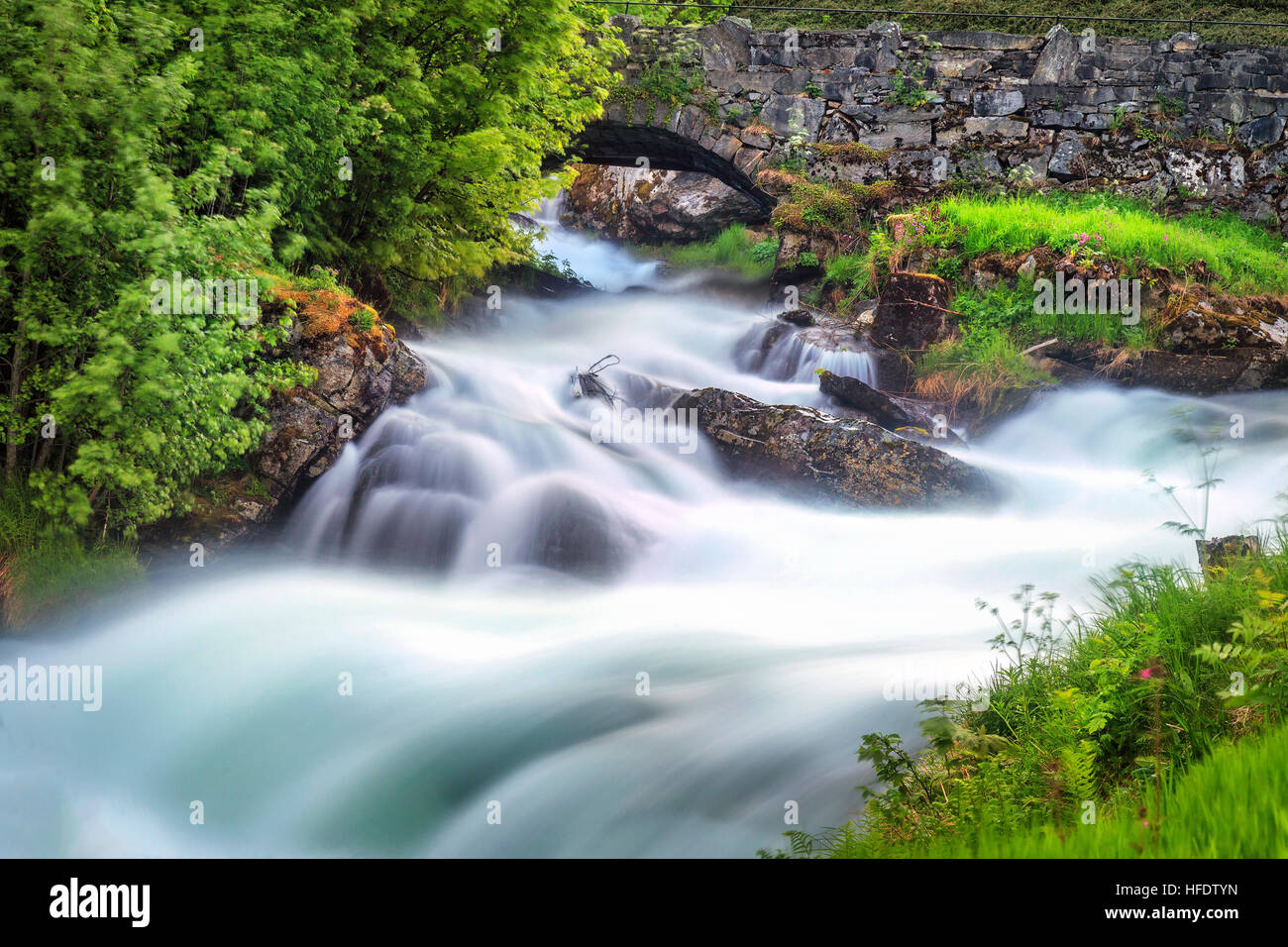 Water rushing under a stone bridge at Geiranger, Norway Stock Photo - Alamy