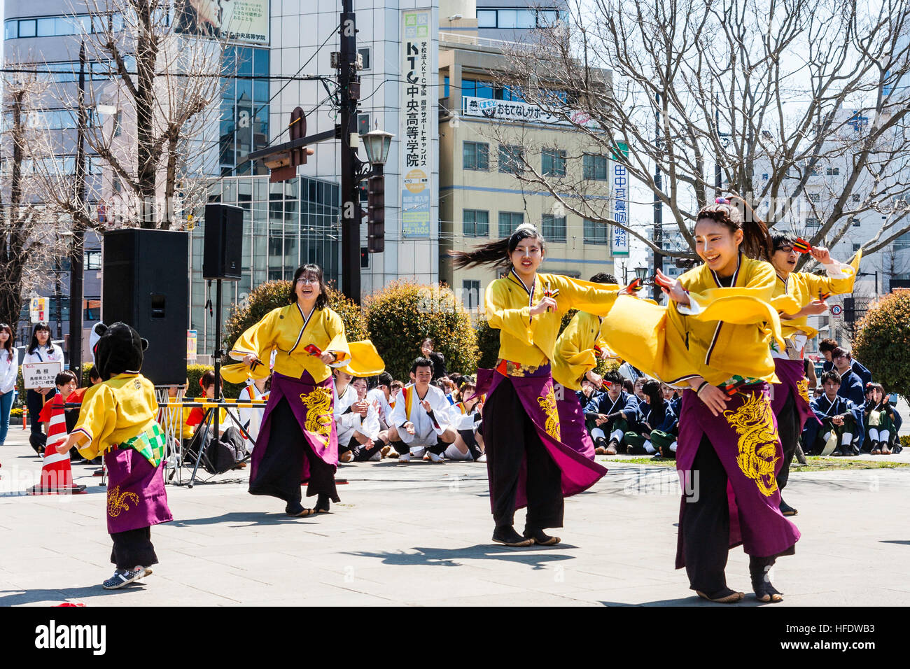 Japanese Yosakoi Festival. Young women dance team in yellow yukata ...
