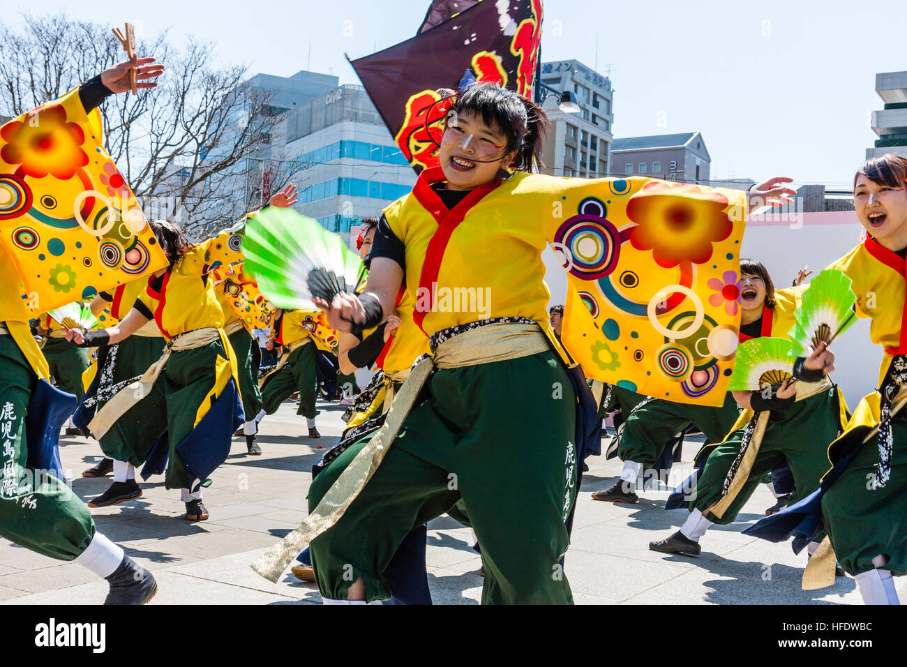 Japanese Yosakoi dance Festival. Young women dancers in yellow yukata ...