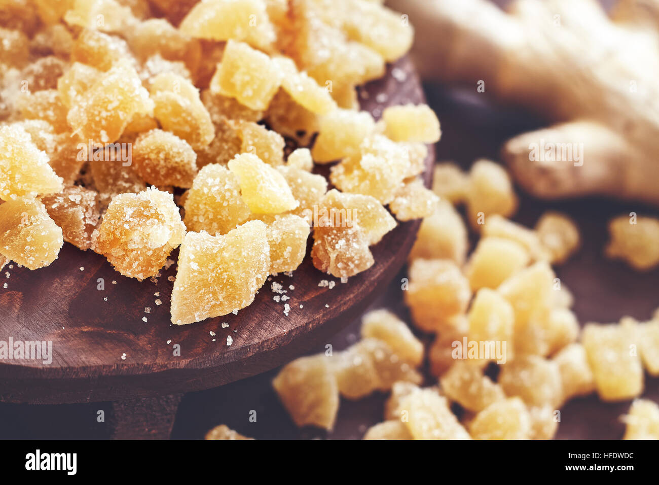 Pile of candied ginger on brown wooden background Stock Photo - Alamy