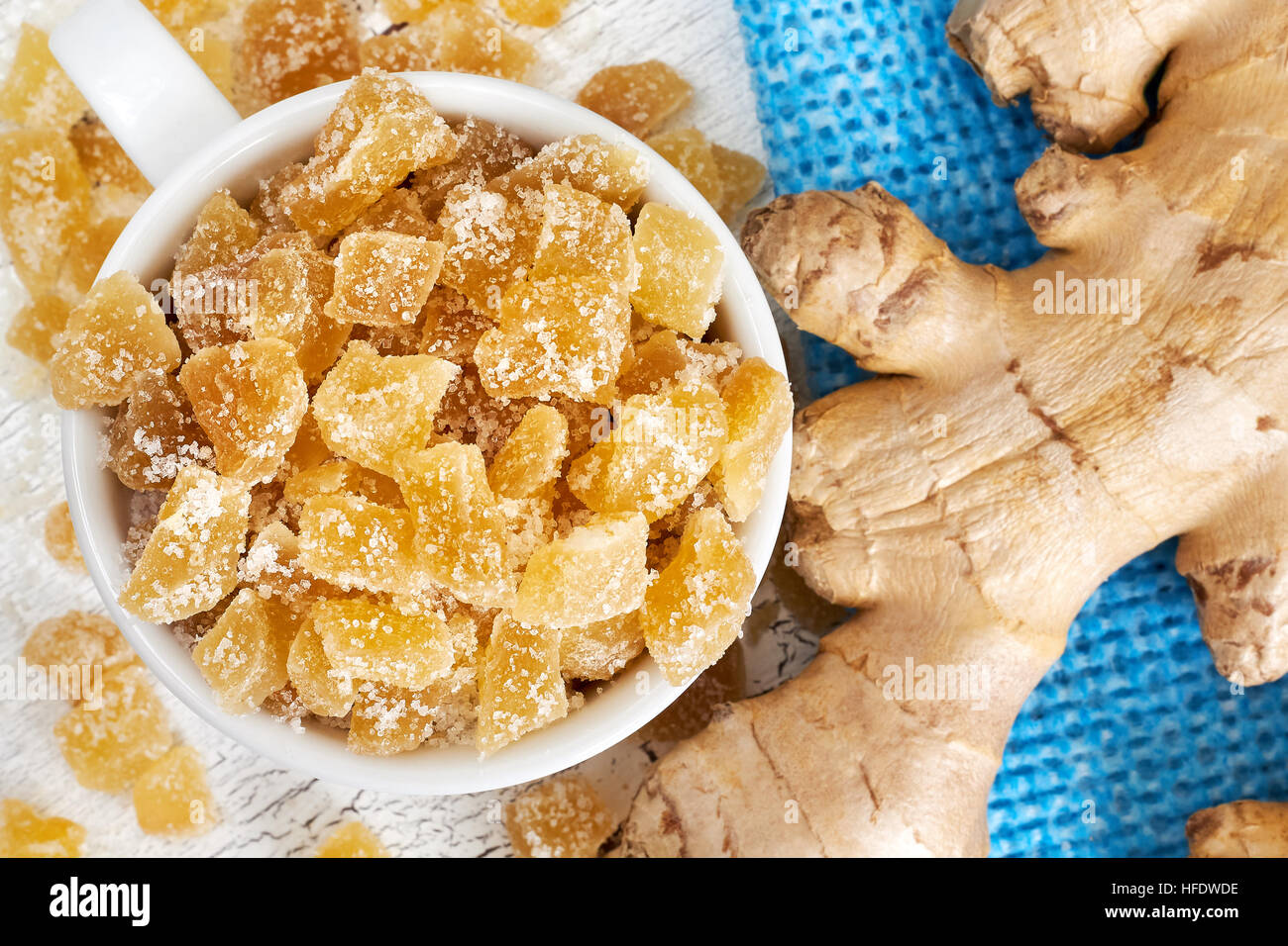 Candied ginger on white rustic wooden background. Top view Stock Photo ...