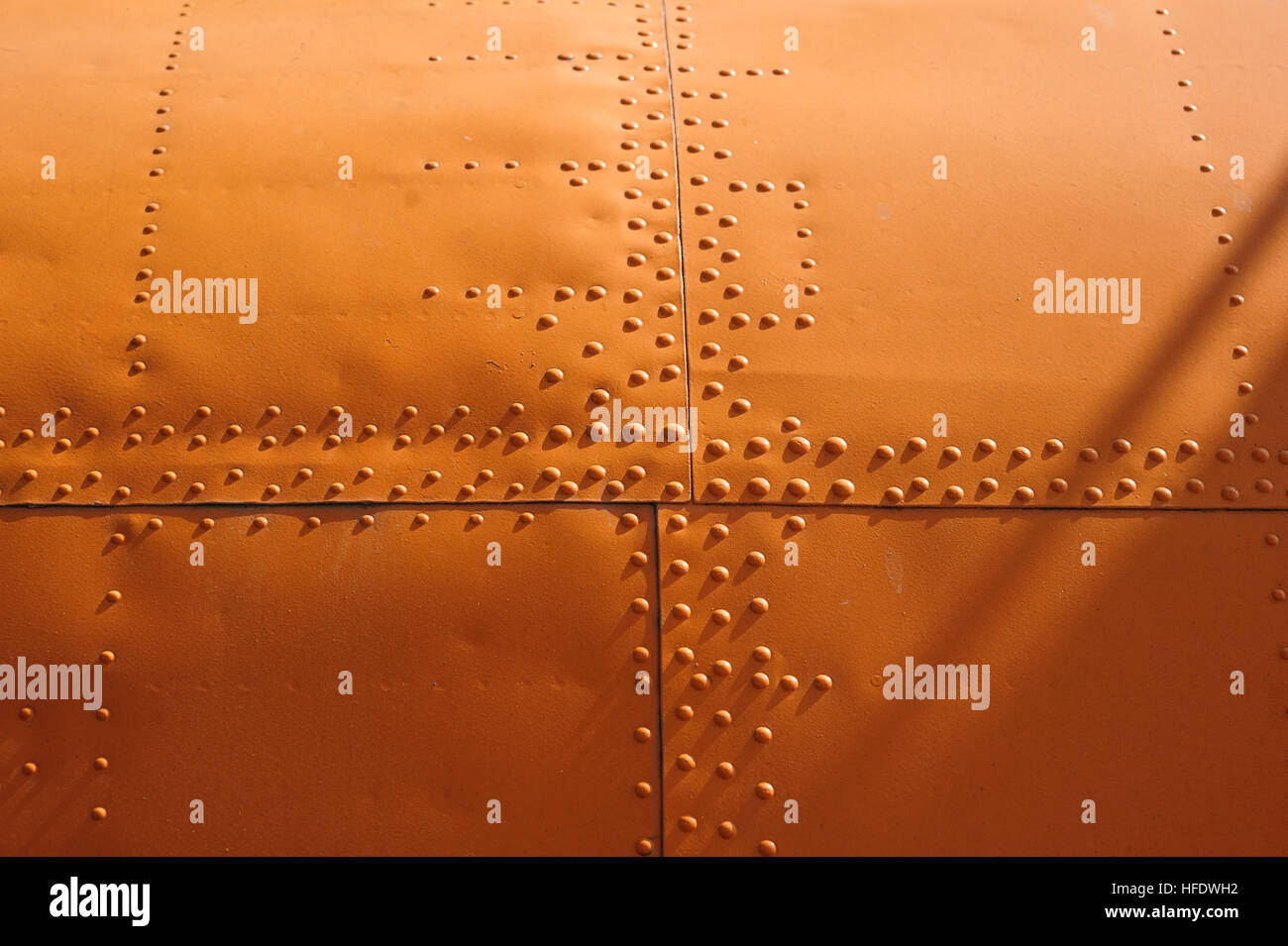 orange texture covering aircraft rivets for background Stock Photo - Alamy