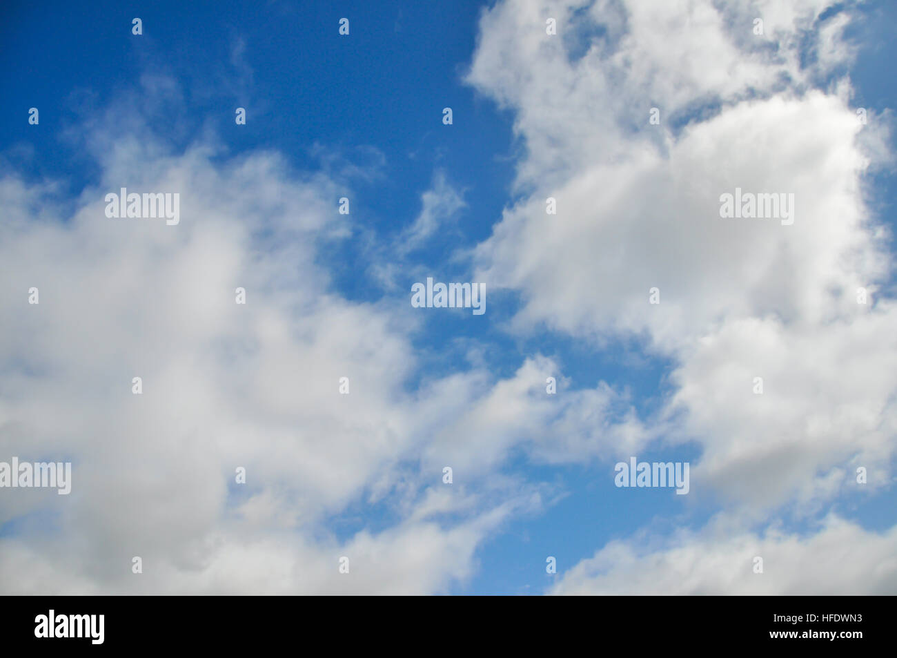 Sunny midday clear blue sky with fluffy white clouds Stock Photo - Alamy