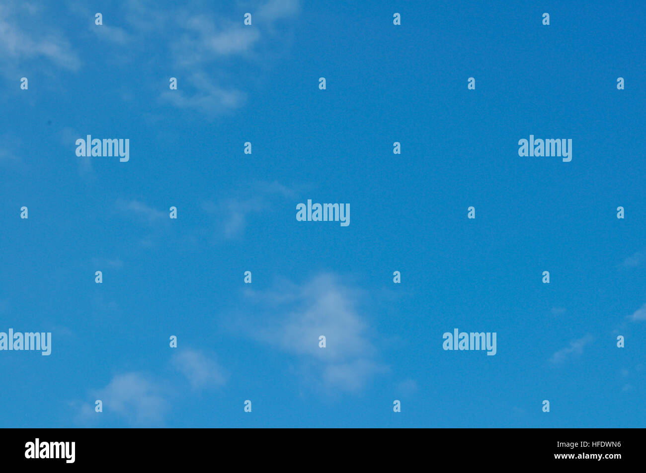 Sunny midday clear blue sky with fluffy white clouds Stock Photo - Alamy