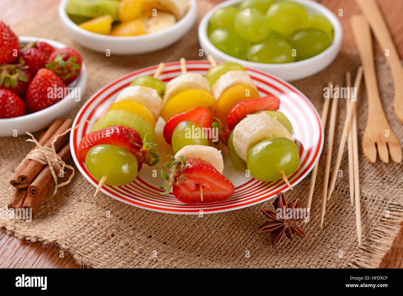 assorted fruit skewers with grapes, kiwi, banana, strawberry and plum ...