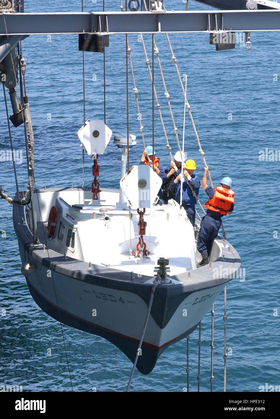 Sailors aboard USS Boxer lower the Captain's Gig, a diesel-powered boat ...