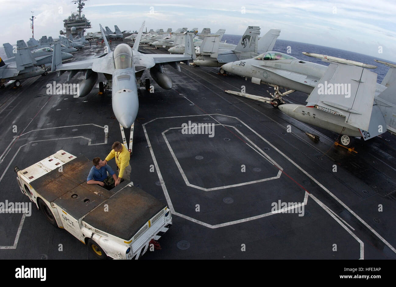 A Chief Petty Officer mentors a Sailor on the flight deck of USS Kitty ...