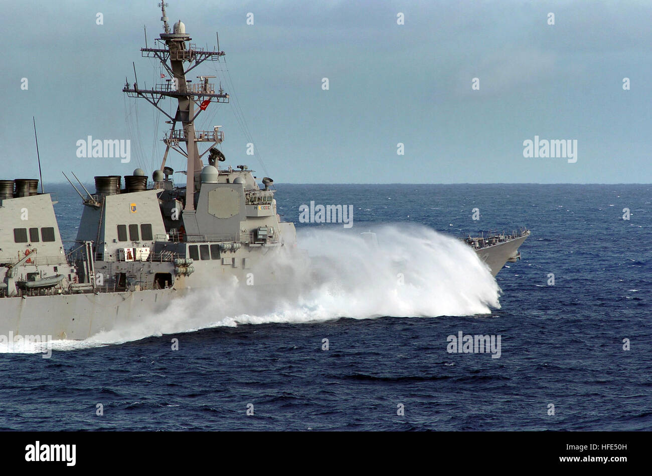 Waves crash over the bow of guided missile destroyer USS Howard (DDG 83 ...