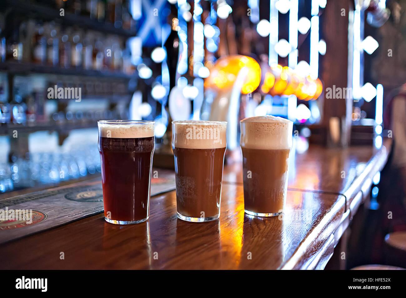 three varieties of freshly brewed natural beer on a dark pub Stock ...