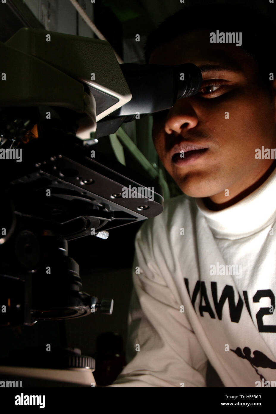 A Hospital Corpsman examines medical slides aboard USS Harry S. Truman ...