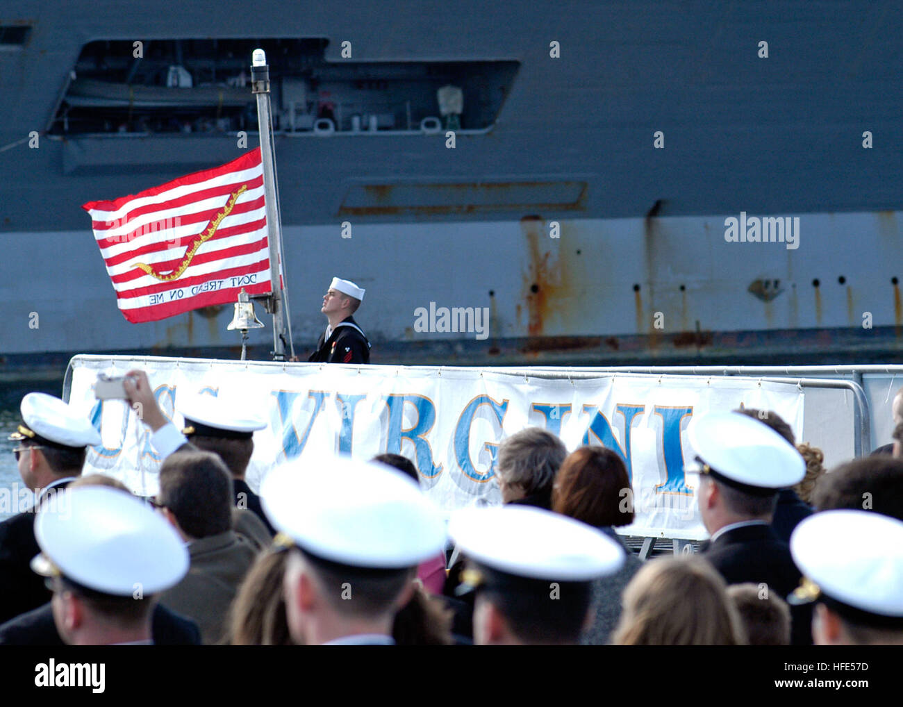 A sailor raises the Union Jack as the USS Virginia (SSN 774) is being ...