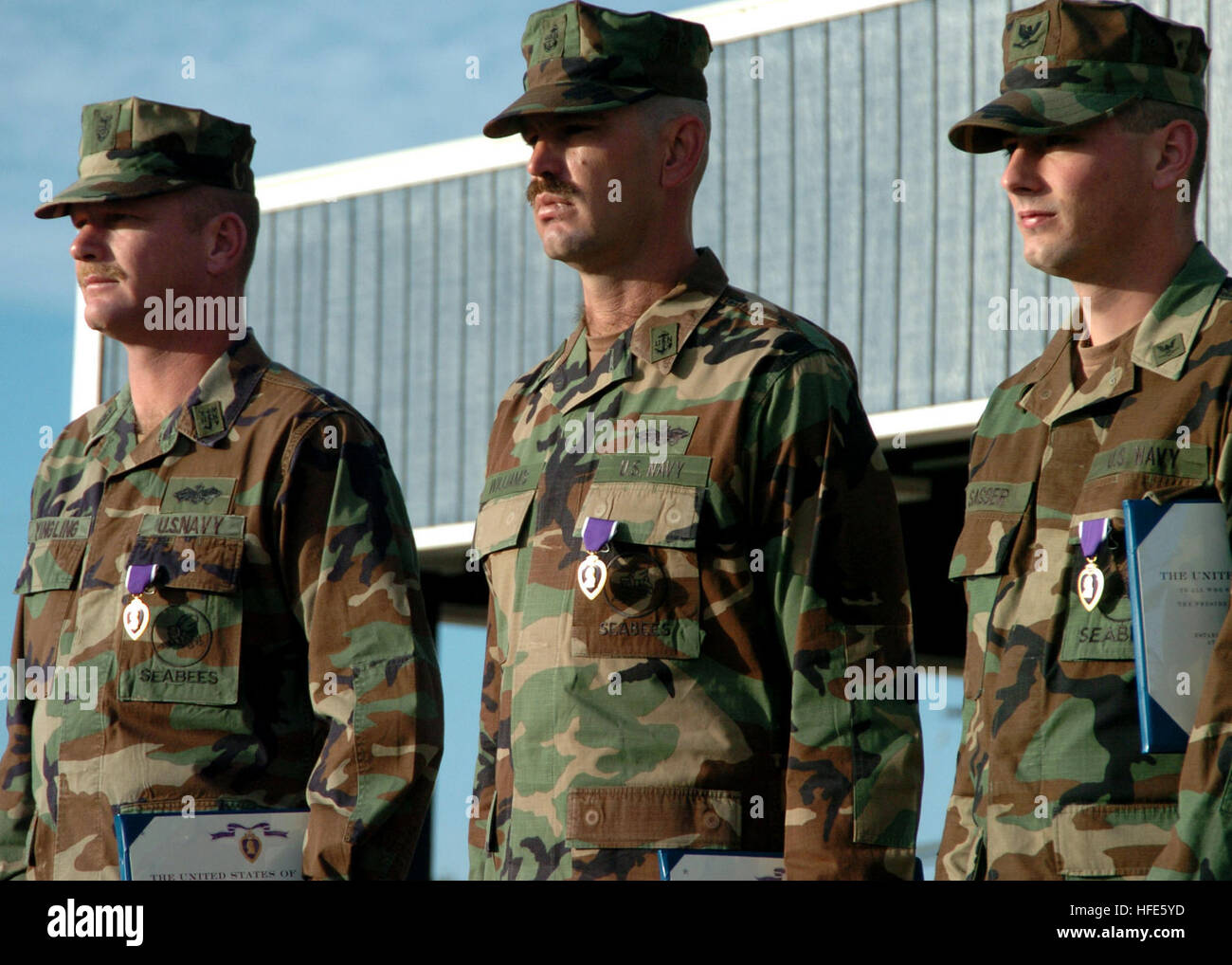 Three members of Naval Mobile Construction Battalion Four (NMCB-4 ...