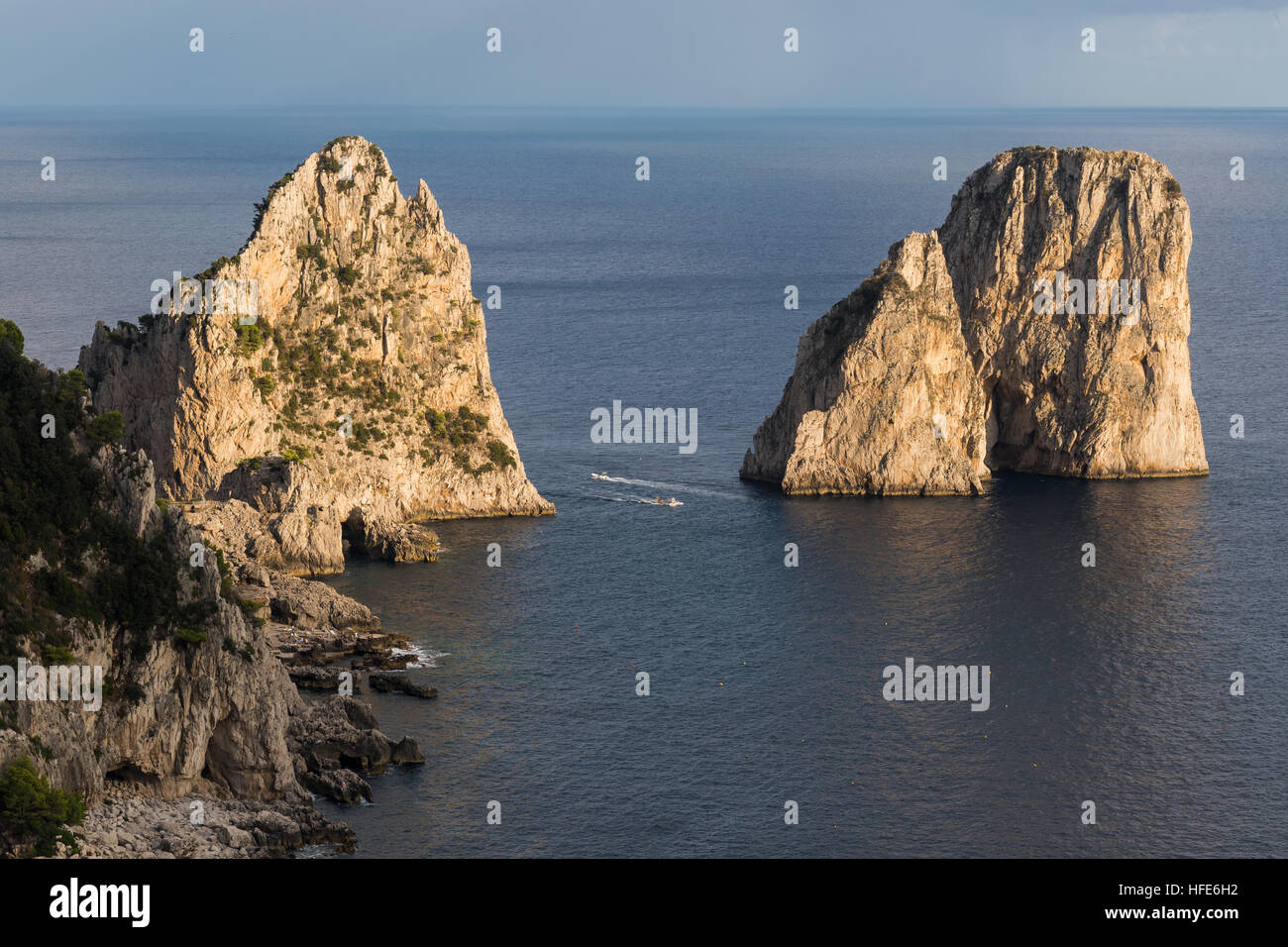Coastal and oceanic rocks Faraglioni into the sunset Capri, an island ...