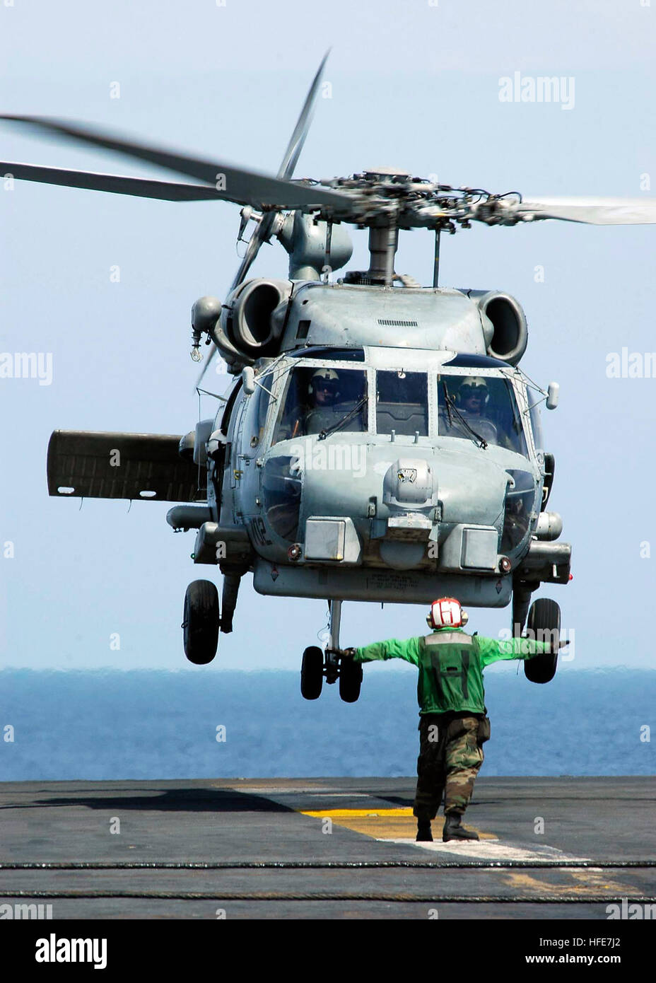 An SH-60B Seahawk from HSL-47 Saberhawks lands on USS Abraham Lincoln ...