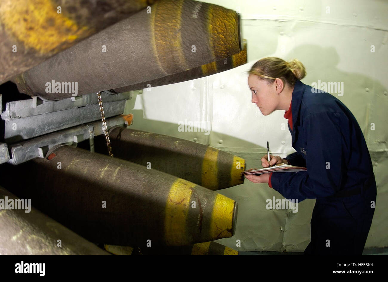Airman catalogs and inventories BLU-109 2000-pound bombs in USS Kitty ...