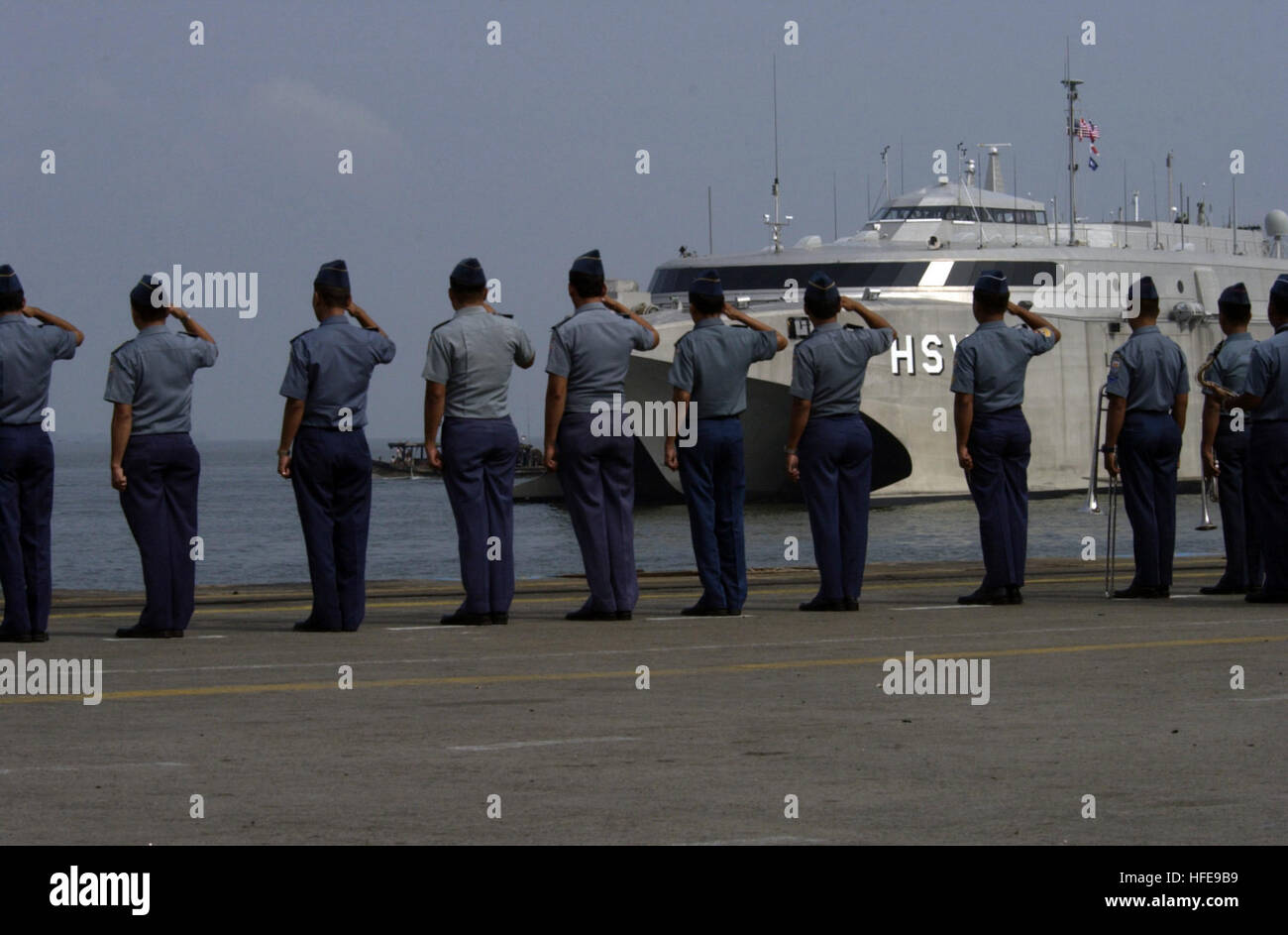 Belawan, Indonesia-- Indonesian military personnel render a salute to ...