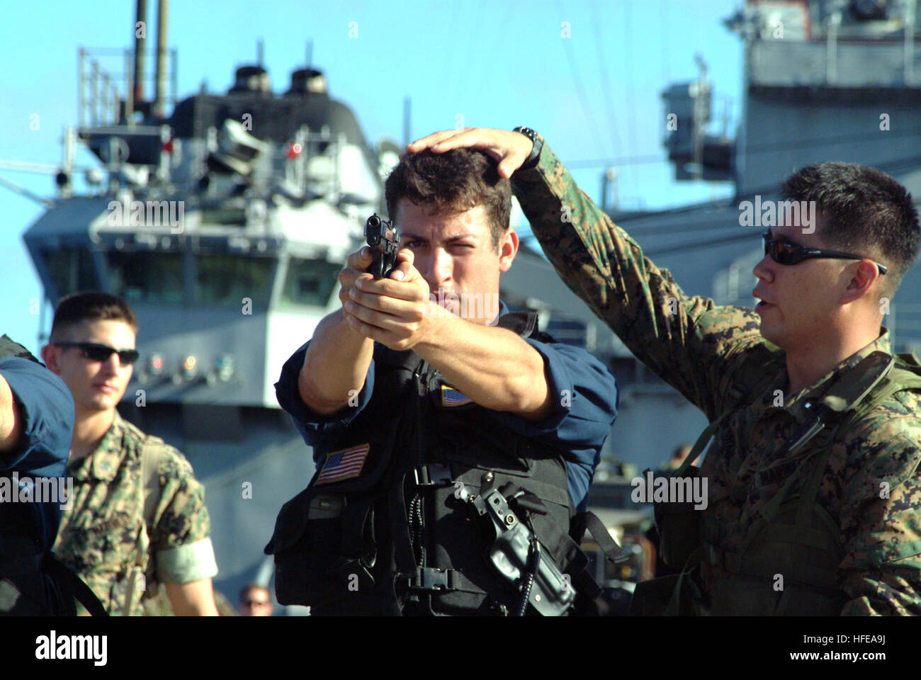 A Gunner's Mate receives weapons training with an unloaded 9mm pistol ...