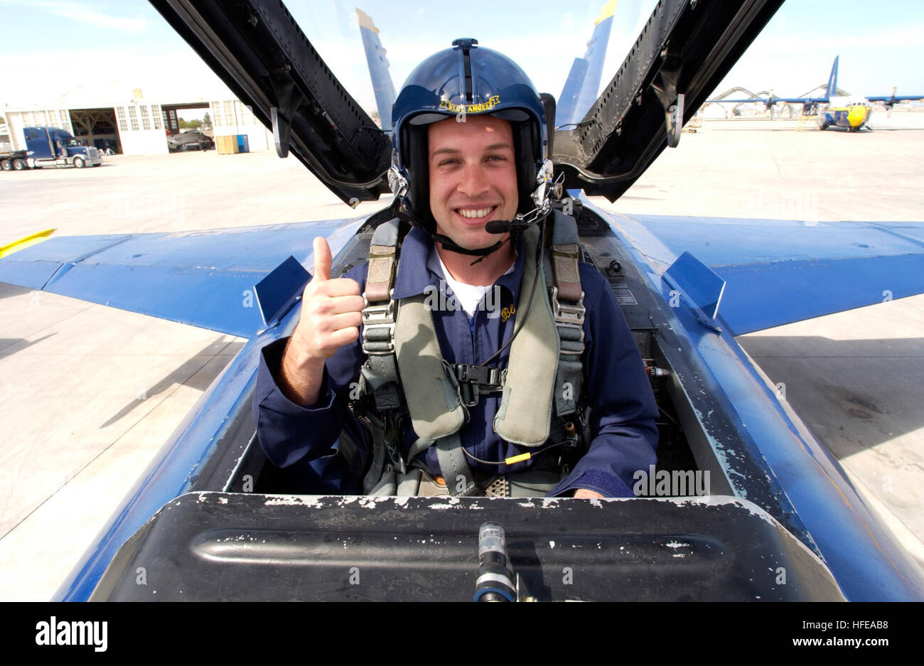 A racing team driver is seated in the back of a U.S. Navy Blue Angels F ...