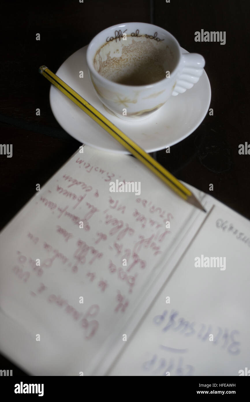 at the end of the coffee break with block note and an empty cup of ...