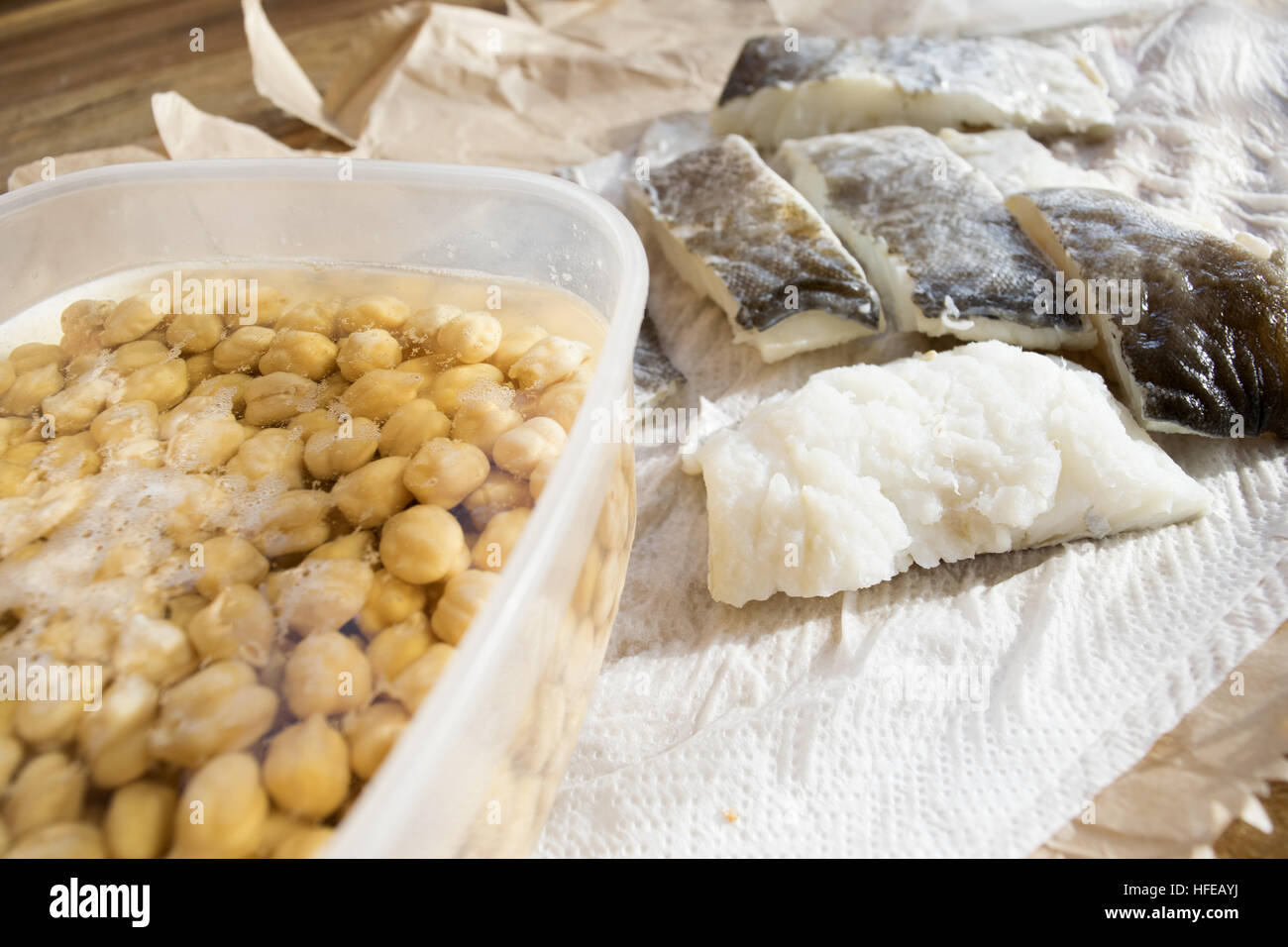 raw fillets of salted codfish with chickpeas in soaking Stock Photo - Alamy