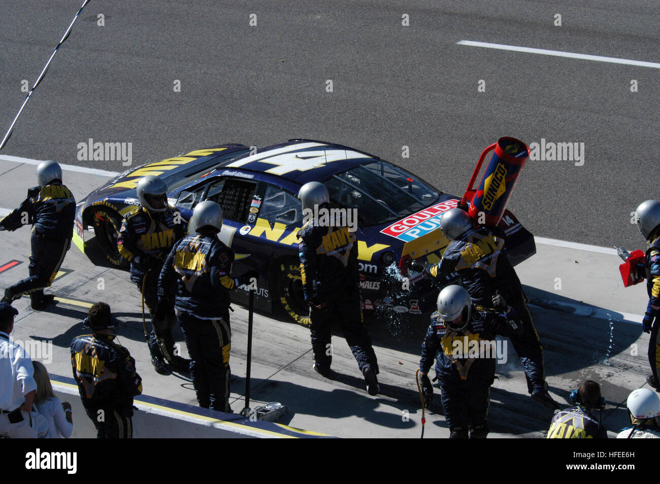 A U.S. Navy-sponsored NASCAR pit crew works to get driver David Streeme ...