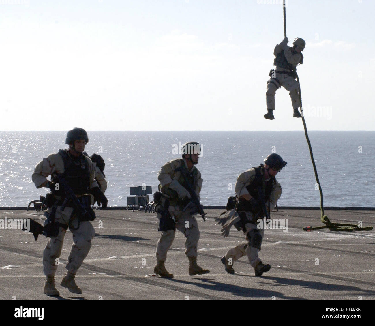 U.S. Navy SEALs fast-rope from a helicopter to USS Mount Whitney (LCC ...