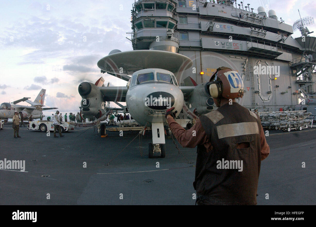 A plane captain from VAW-112 signals an E-2C Hawkeye pilot during ...