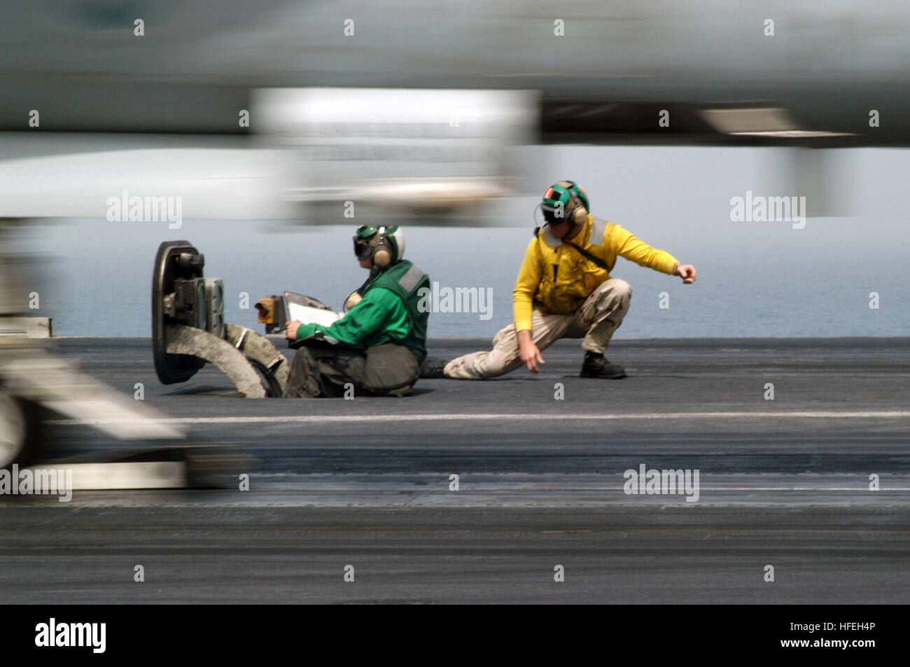 A flight deck Shooter signals catapult operators as an F/A-18C Hornet ...