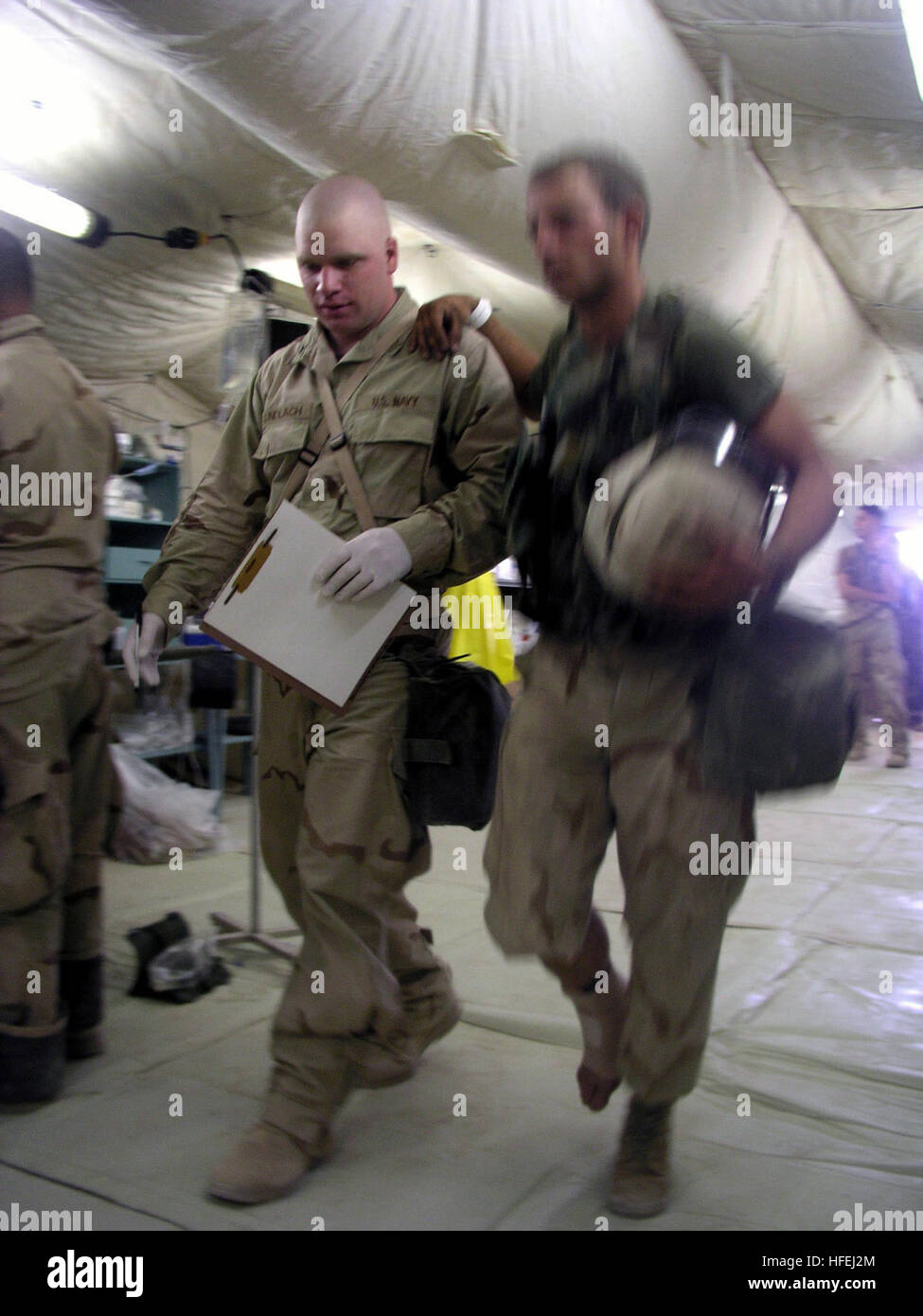 Hospital Corpsman provides care to a Marine in the Casualty Receiving ...