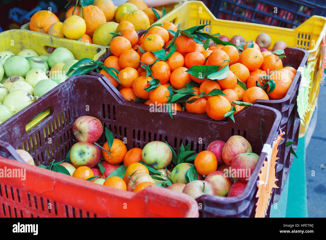 Fruit overflowing boxes on the counter of the local market, tangerines ...