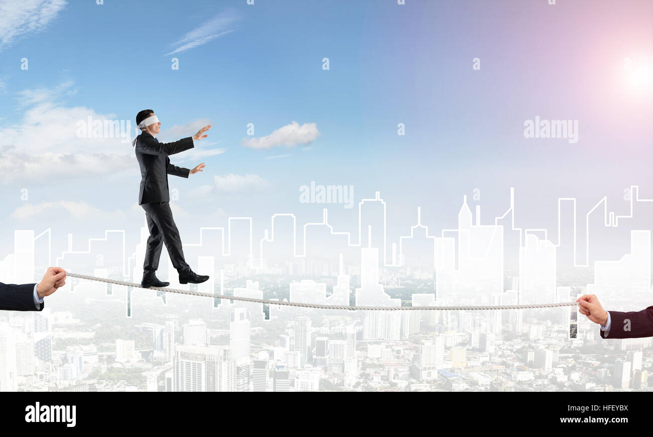 Business concept of risk support and assistance with man balancing on ...