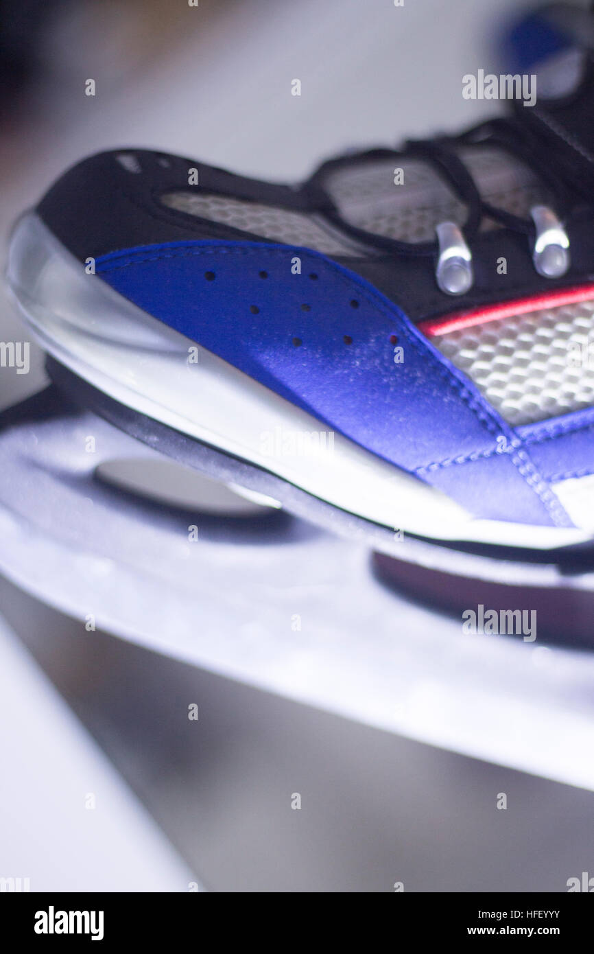 Ice skates in skate store shop window on display on sale for skating on ...