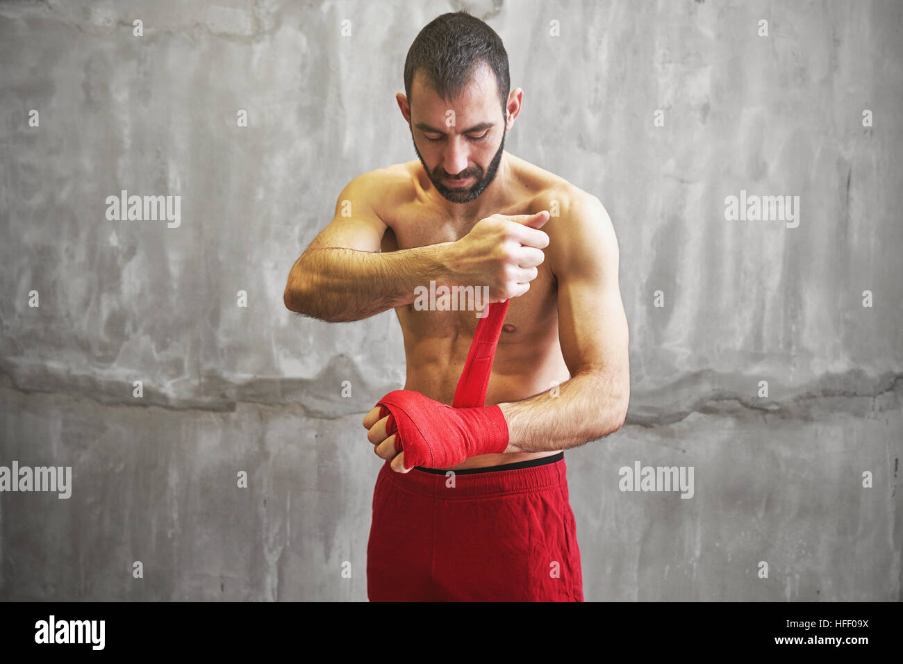 Man is wrapping hands with red boxing wraps Stock Photo - Alamy