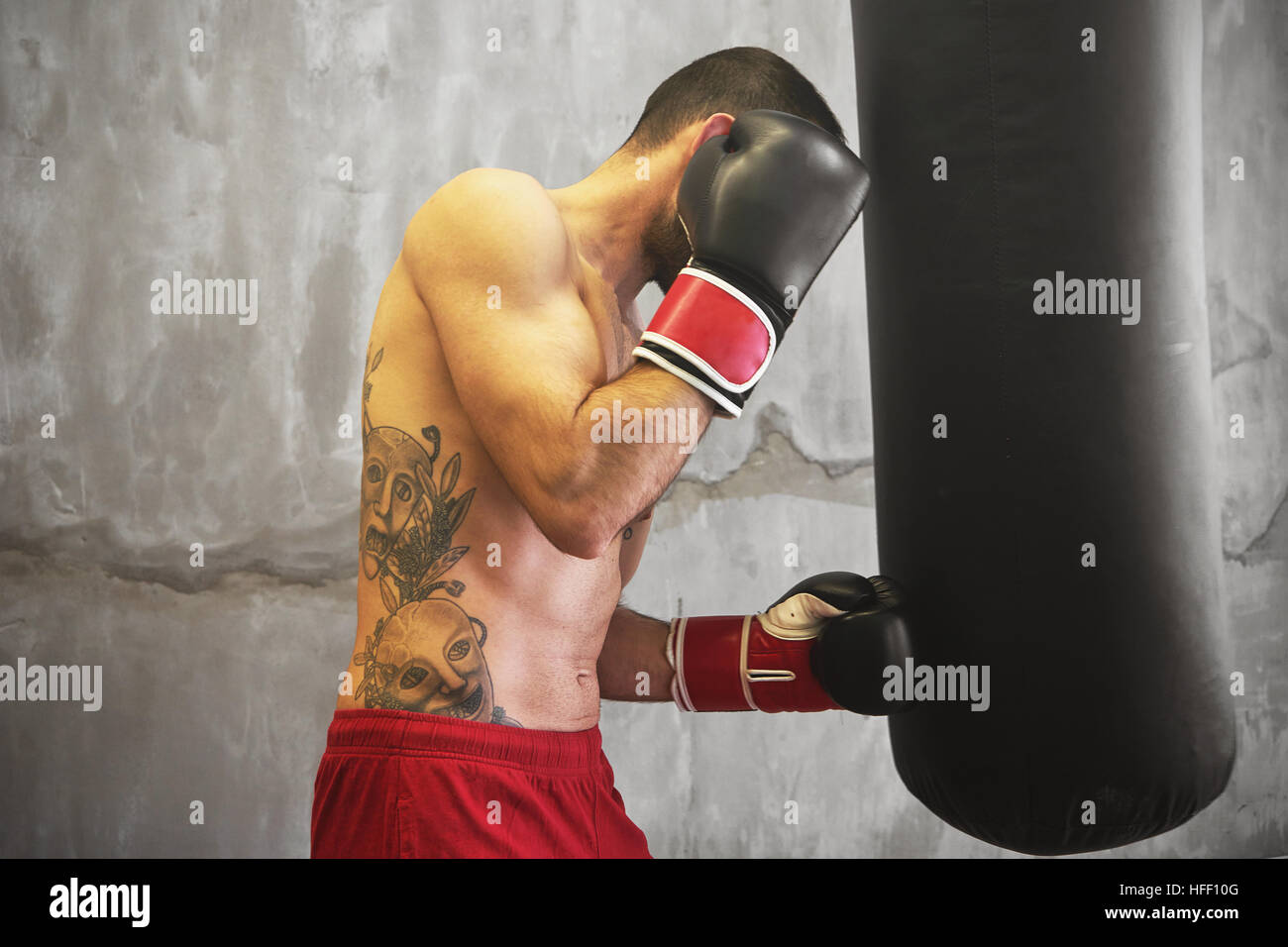 Boxer man doing exercise with punching bag Stock Photo - Alamy