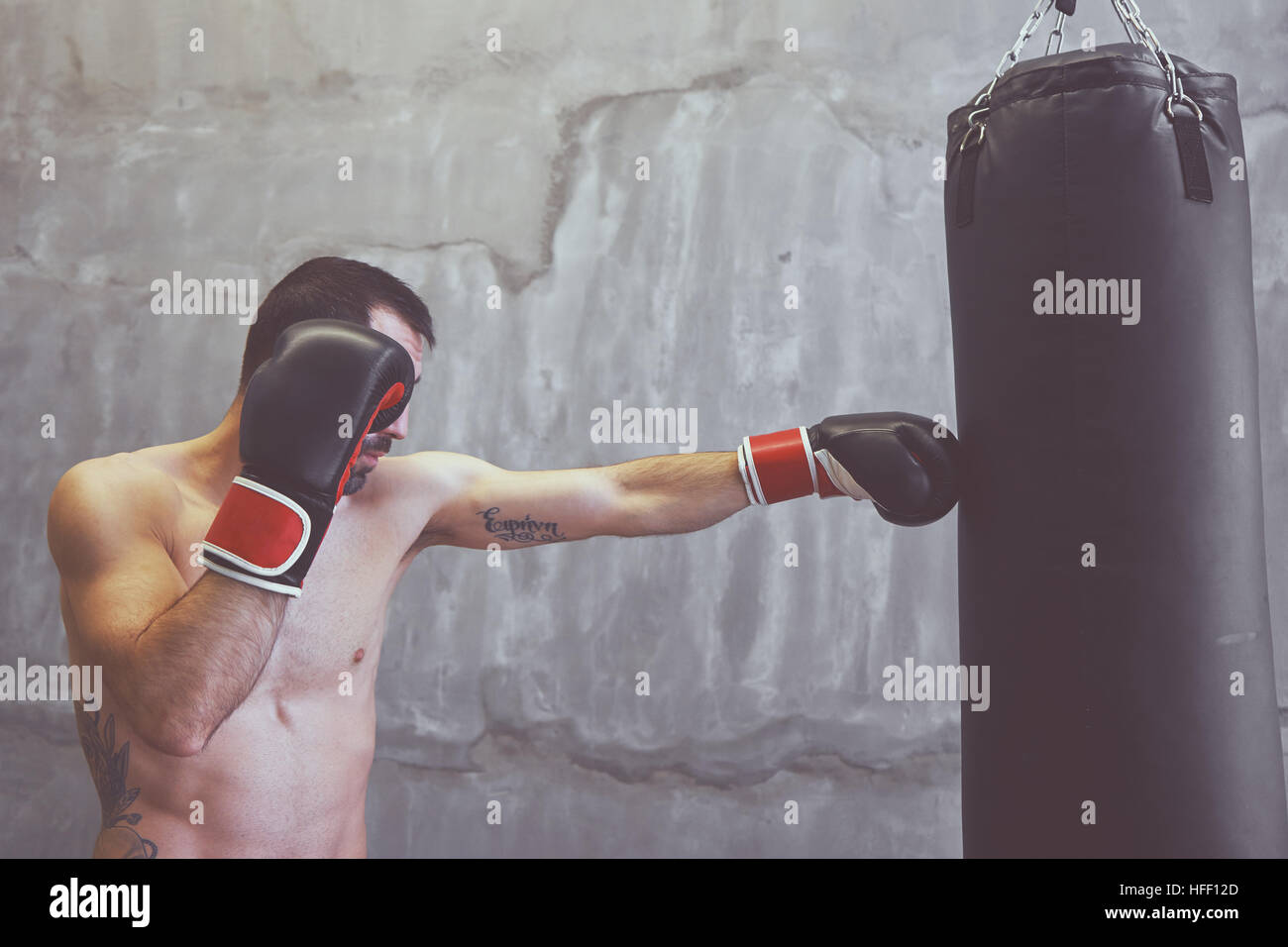 Boxer man doing exercise with punching bag Stock Photo - Alamy
