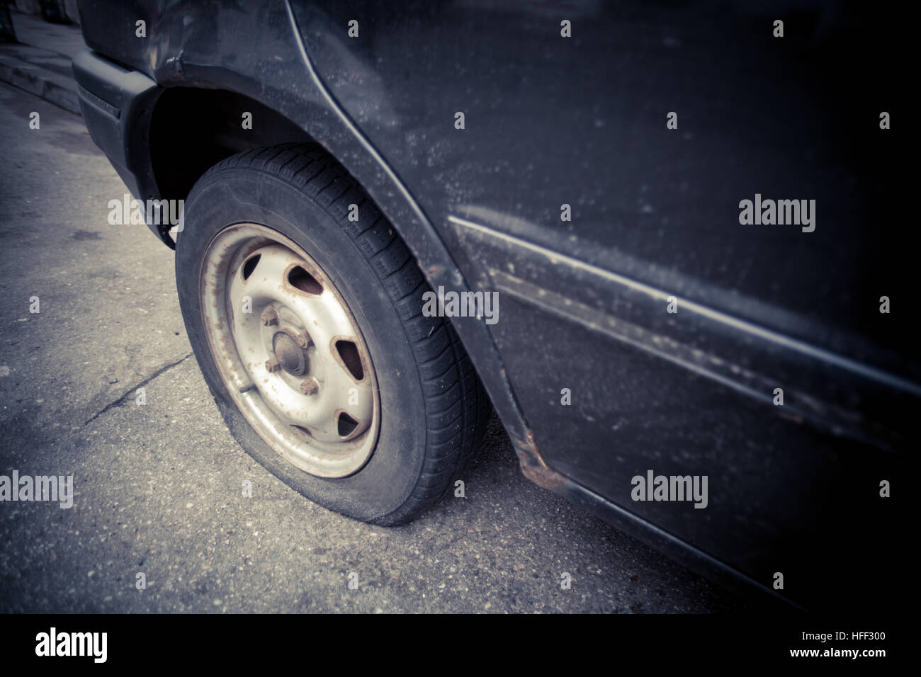Close up shot of a car with a flat tire Stock Photo - Alamy