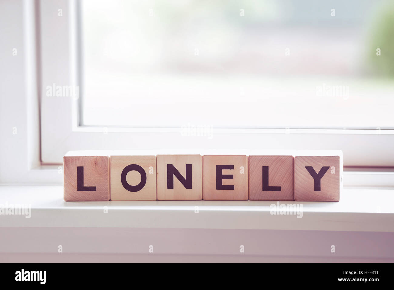 Lonely sign in a bright window at daytime Stock Photo - Alamy