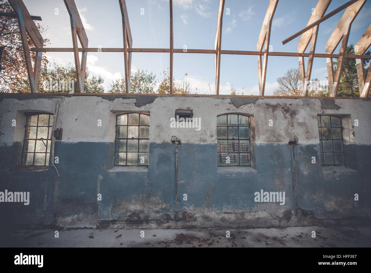 Building without a roof with grunge blue wall and old windows ready for ...