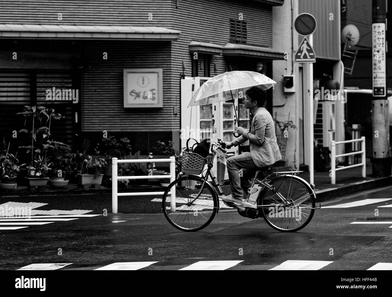 Tokyo Man on Bike Stock Photo - Alamy