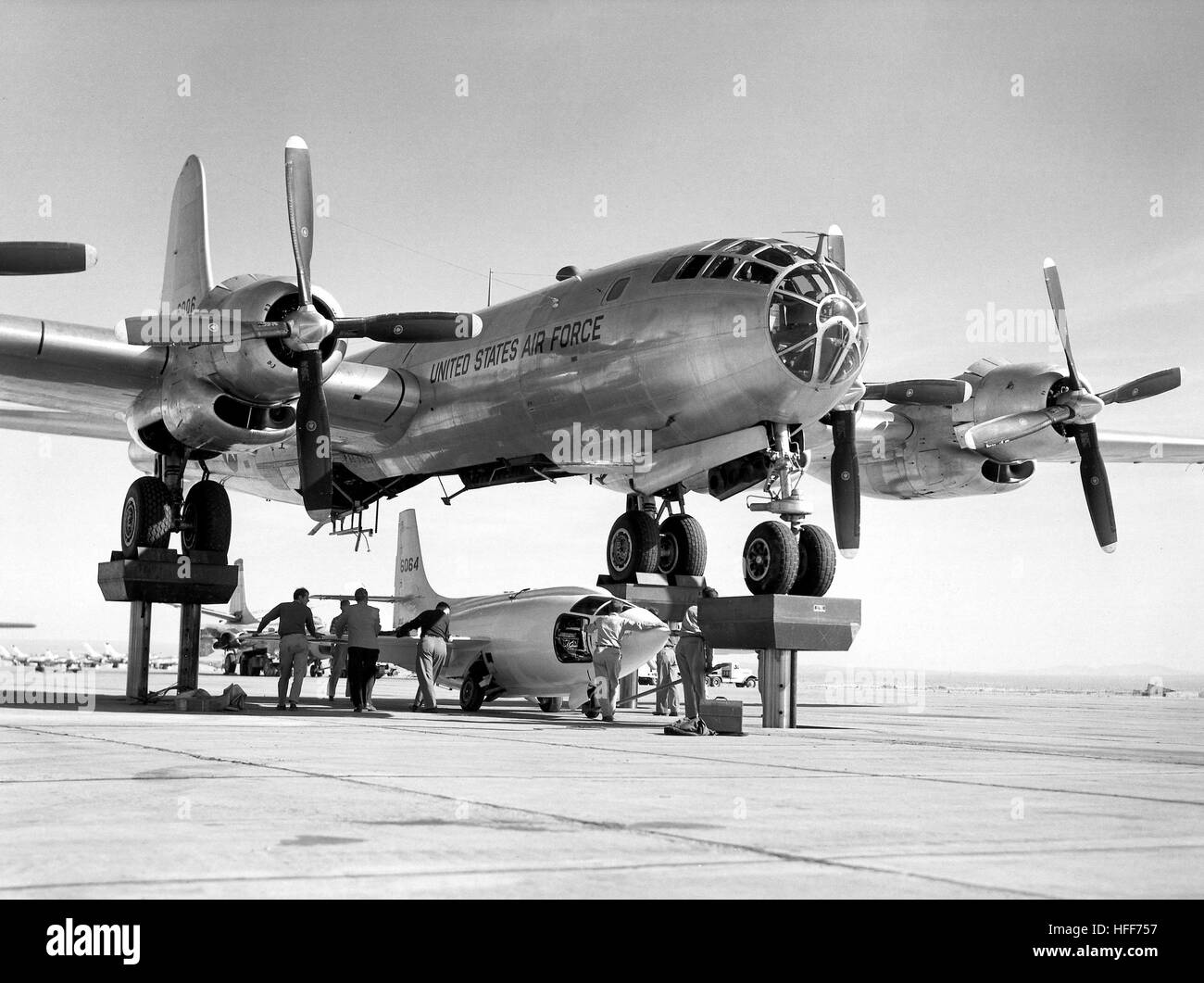 The X-1-3, a rocket-powered aircraft, is seen being mated to the EB-50A ...