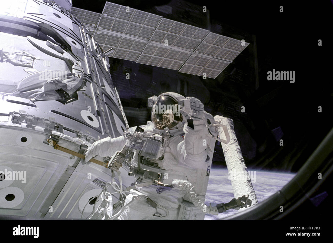 Astronaut Newman is seen waving at the camera from the Unity module ...