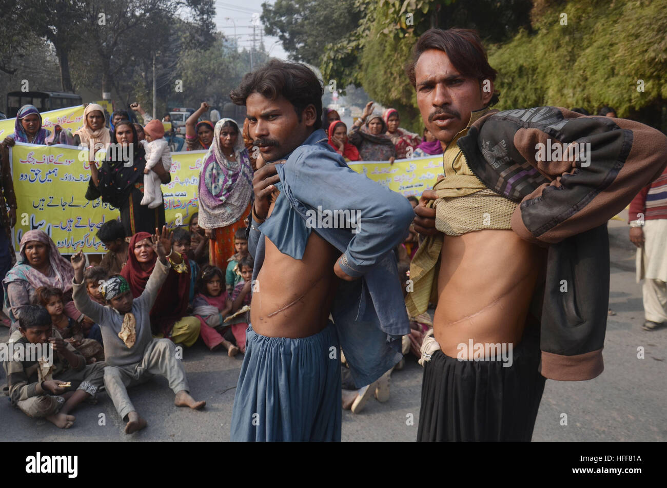 Pakistani poor people hold dry bread as they are protesting against a ...