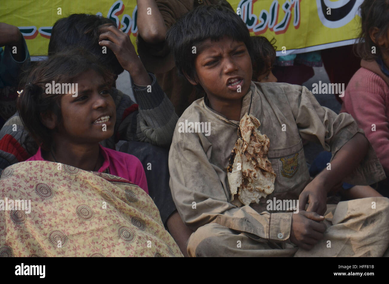 Pakistani poor people hold dry bread as they are protesting against a ...
