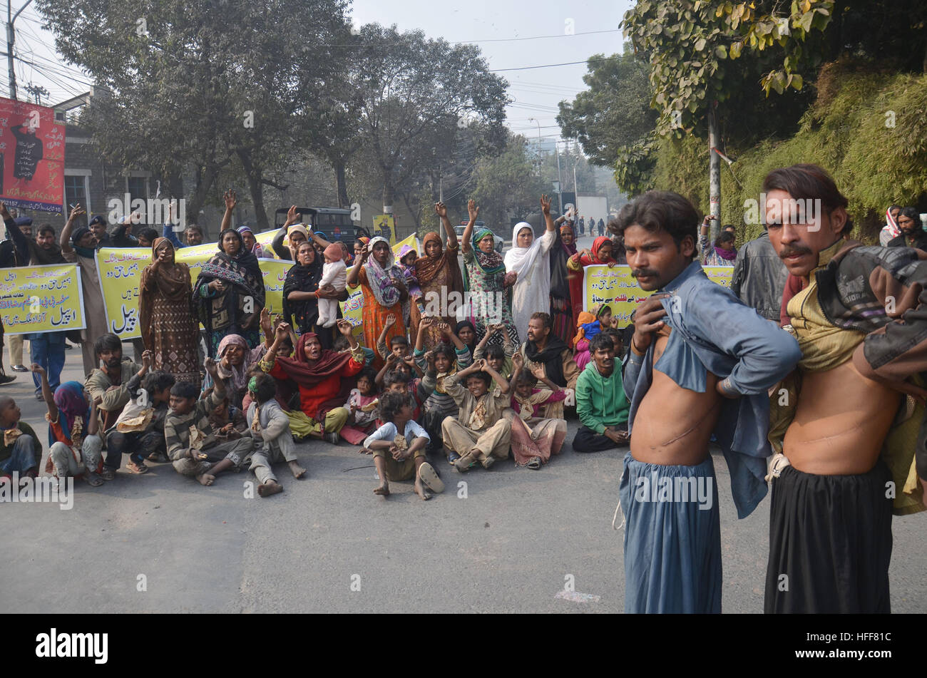 Pakistani poor people hold dry bread as they are protesting against a ...
