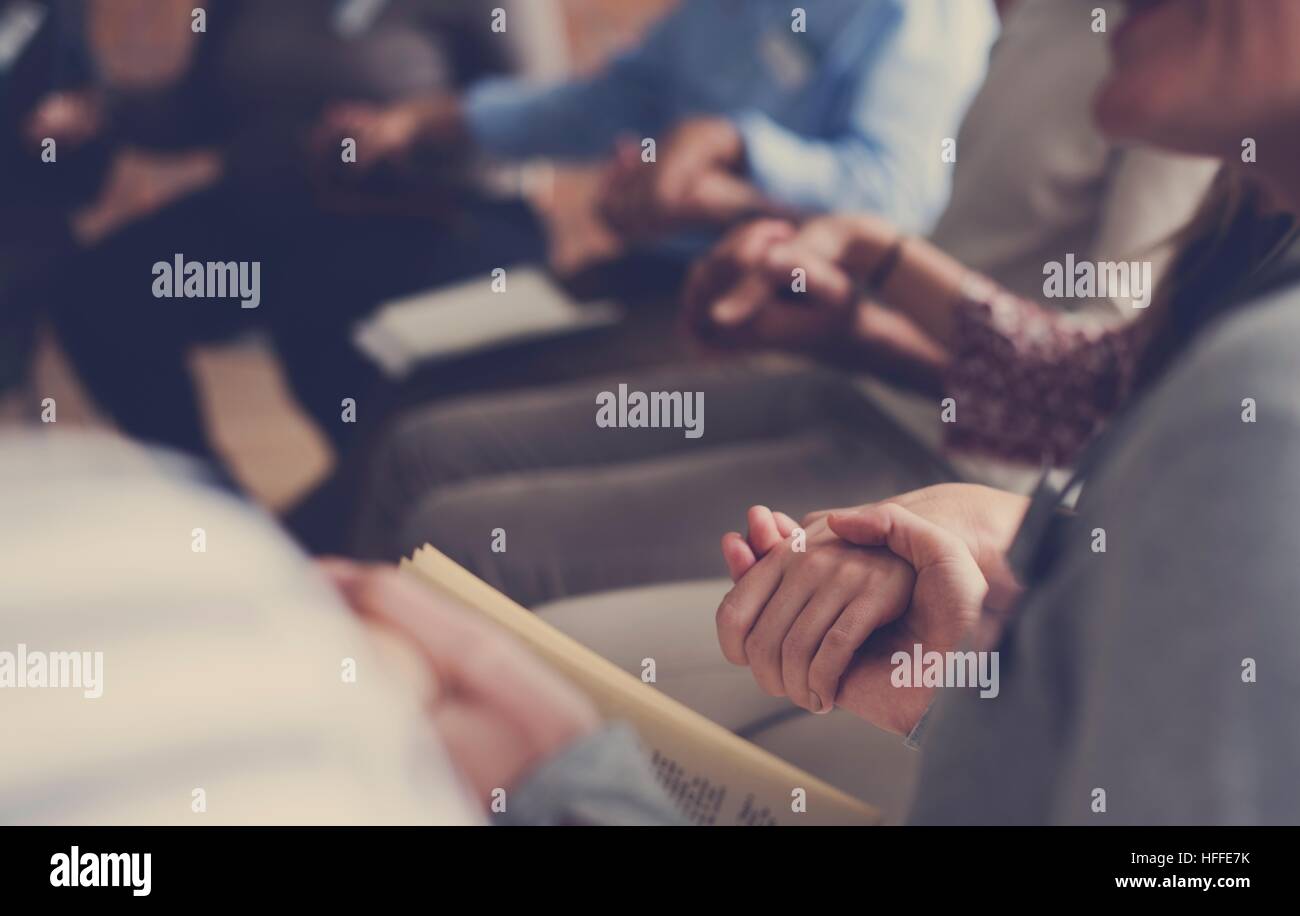 People in a counseling holding hands Stock Photo - Alamy