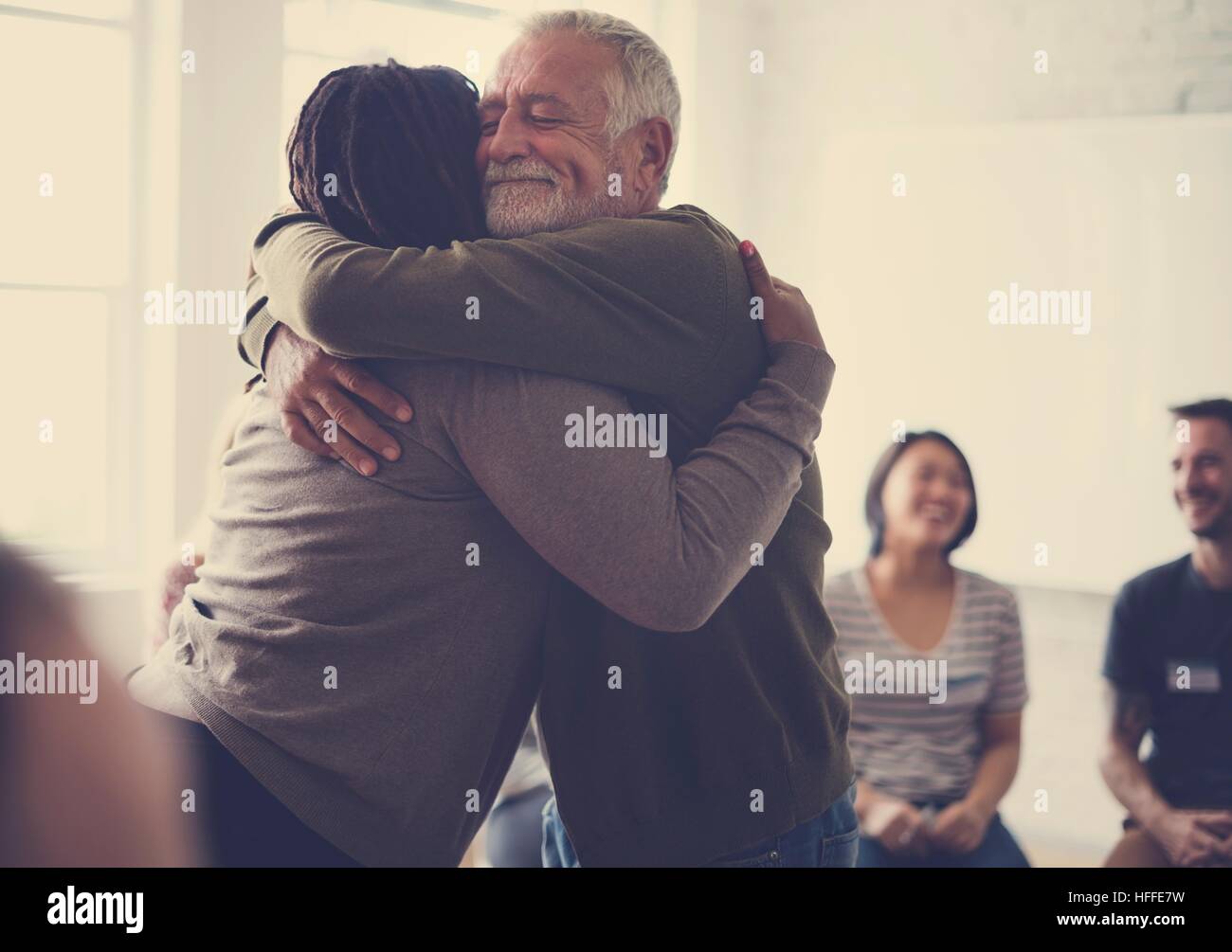 Old guy consoling a woman with a hug Stock Photo - Alamy