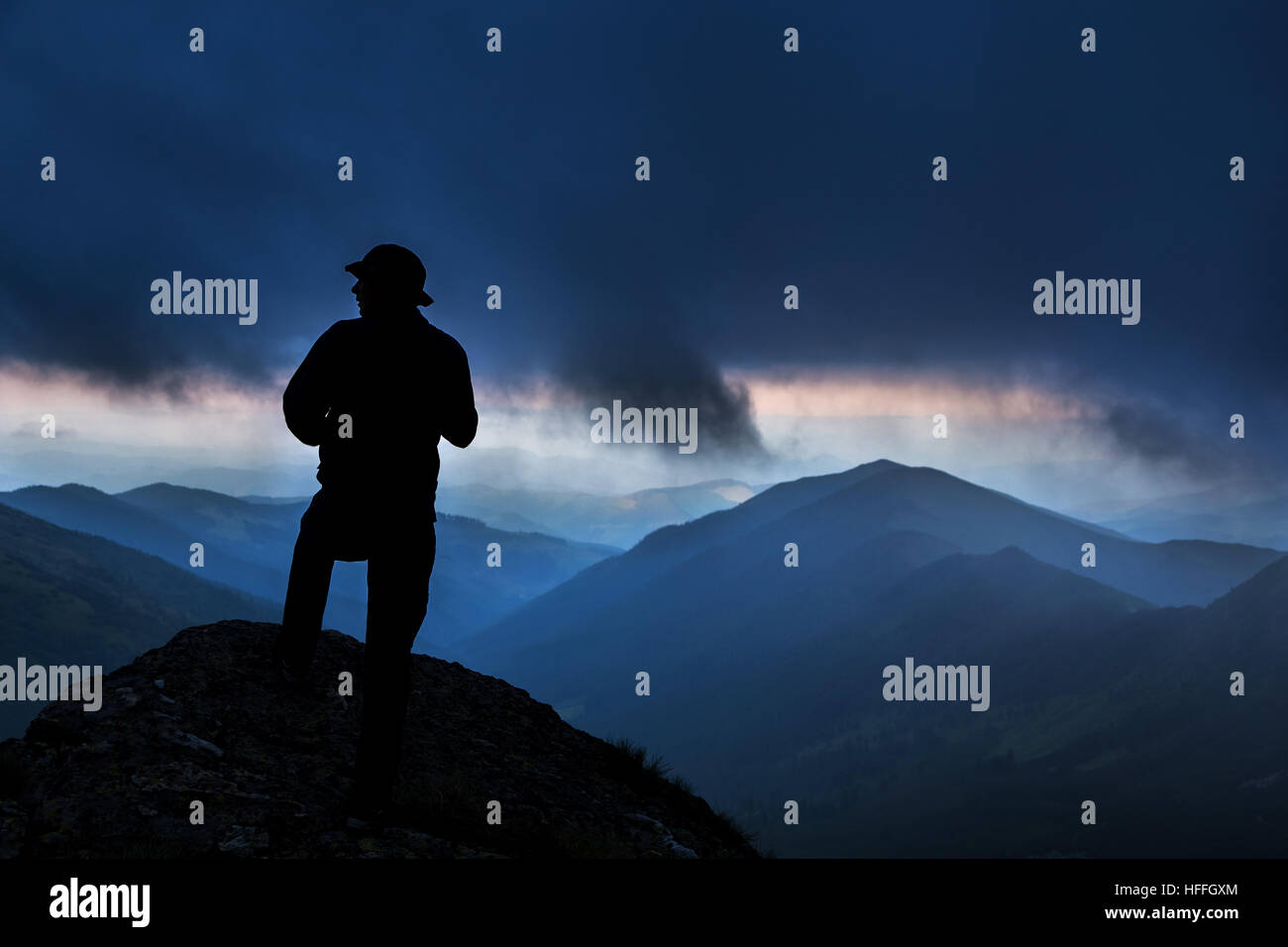 the explorer silhouettes in the mountains Stock Photo - Alamy